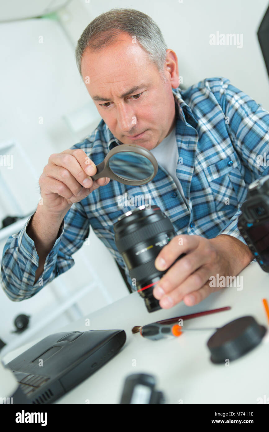 man fixing camera Stock Photo - Alamy