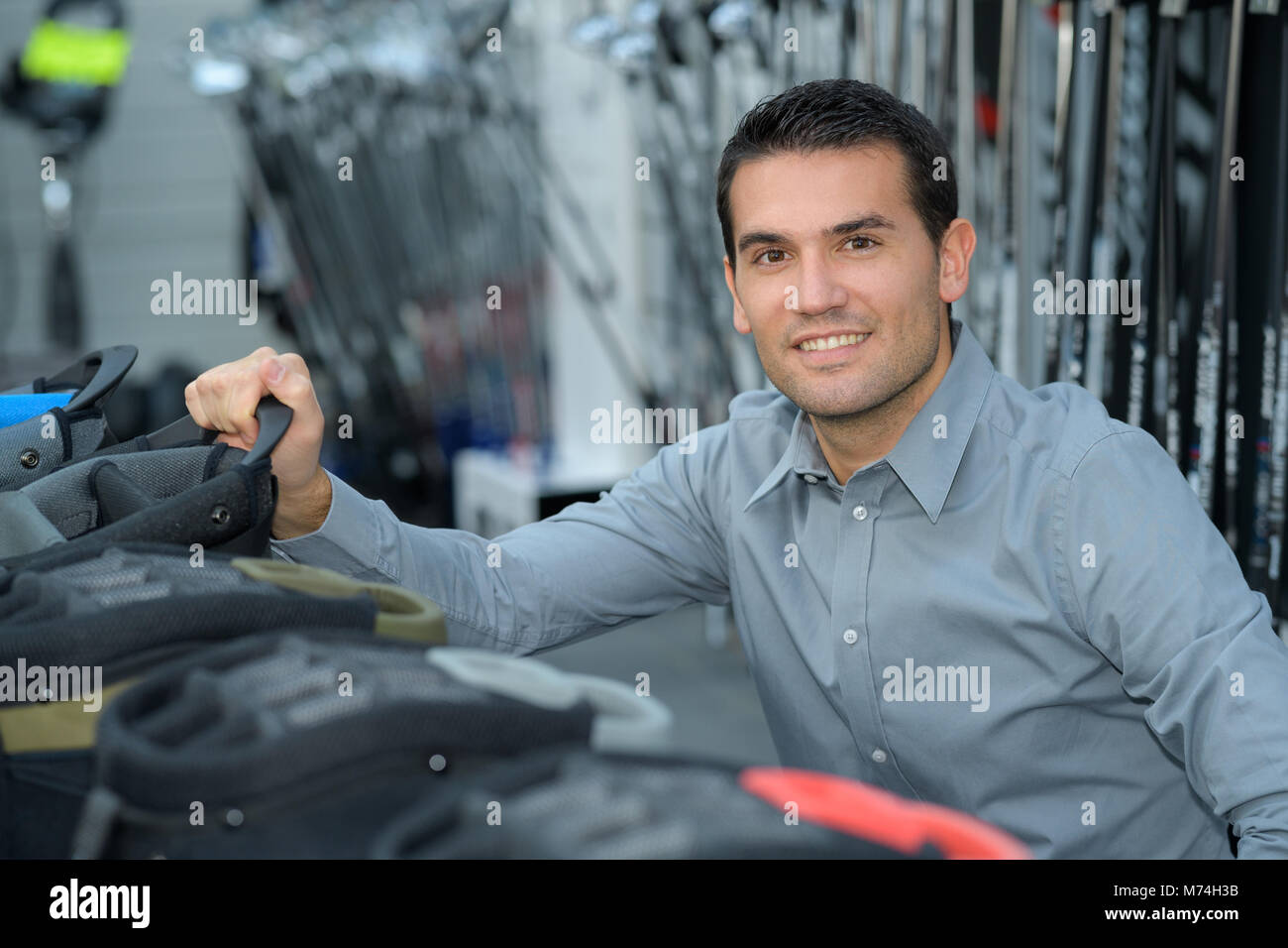 person holding in hand club at a golf shop Stock Photo - Alamy