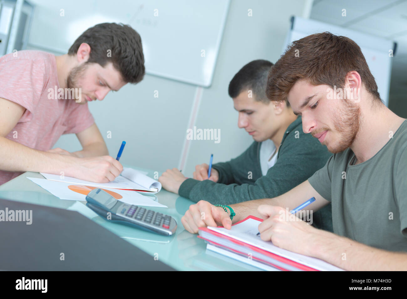 three teens studying together Stock Photo - Alamy