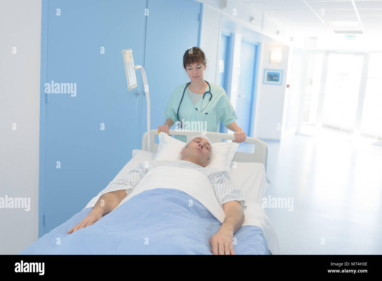 nurse carrying man patient on hospital gurney to emergency Stock Photo ...