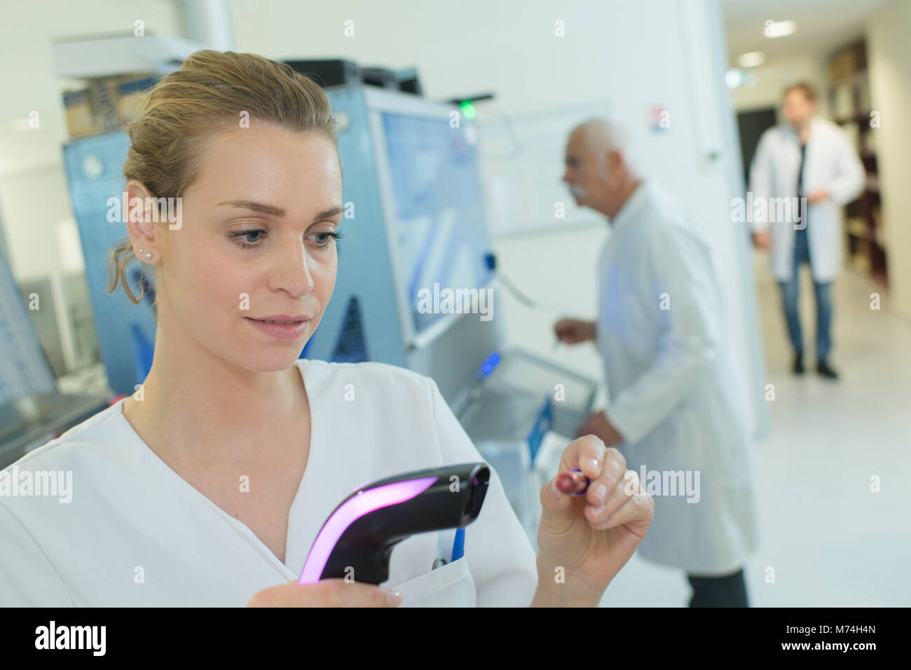 Woman scanning object Stock Photo - Alamy