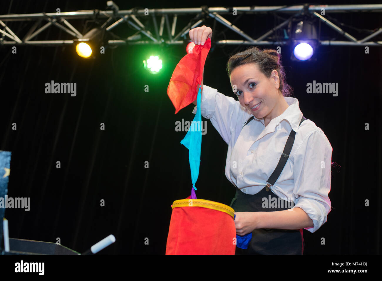Female magician pulling length of material from bag Stock Photo - Alamy