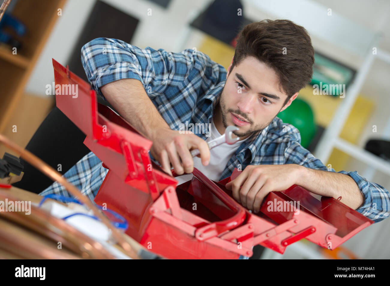 Young man with open toolbox Stock Photo - Alamy