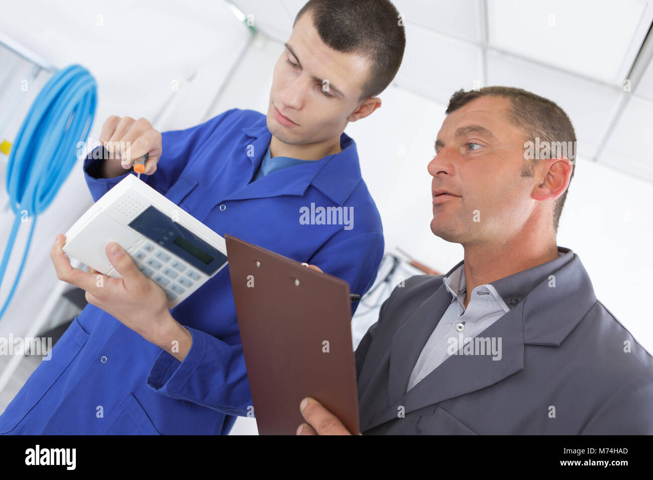 two male plumber working together Stock Photo - Alamy