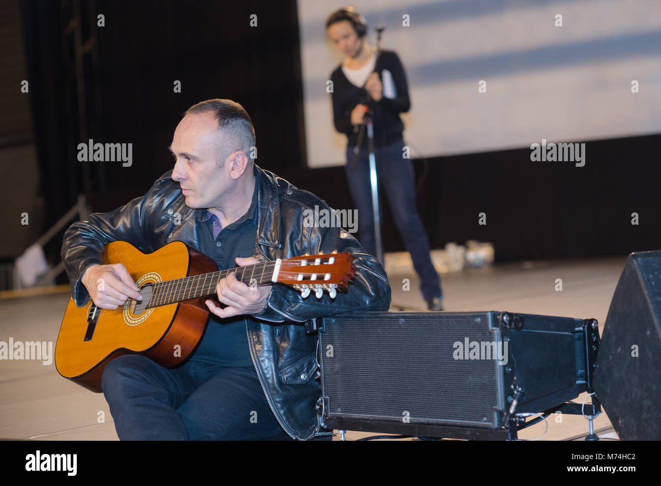 guitarist and singer performing live on stage Stock Photo - Alamy