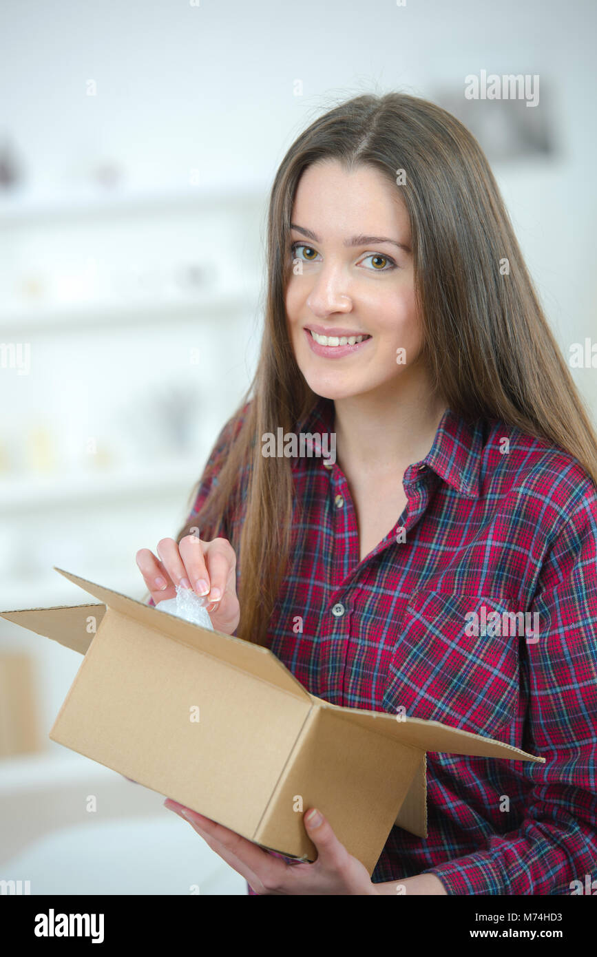 Portrait of girl holding open cardboard box Stock Photo - Alamy