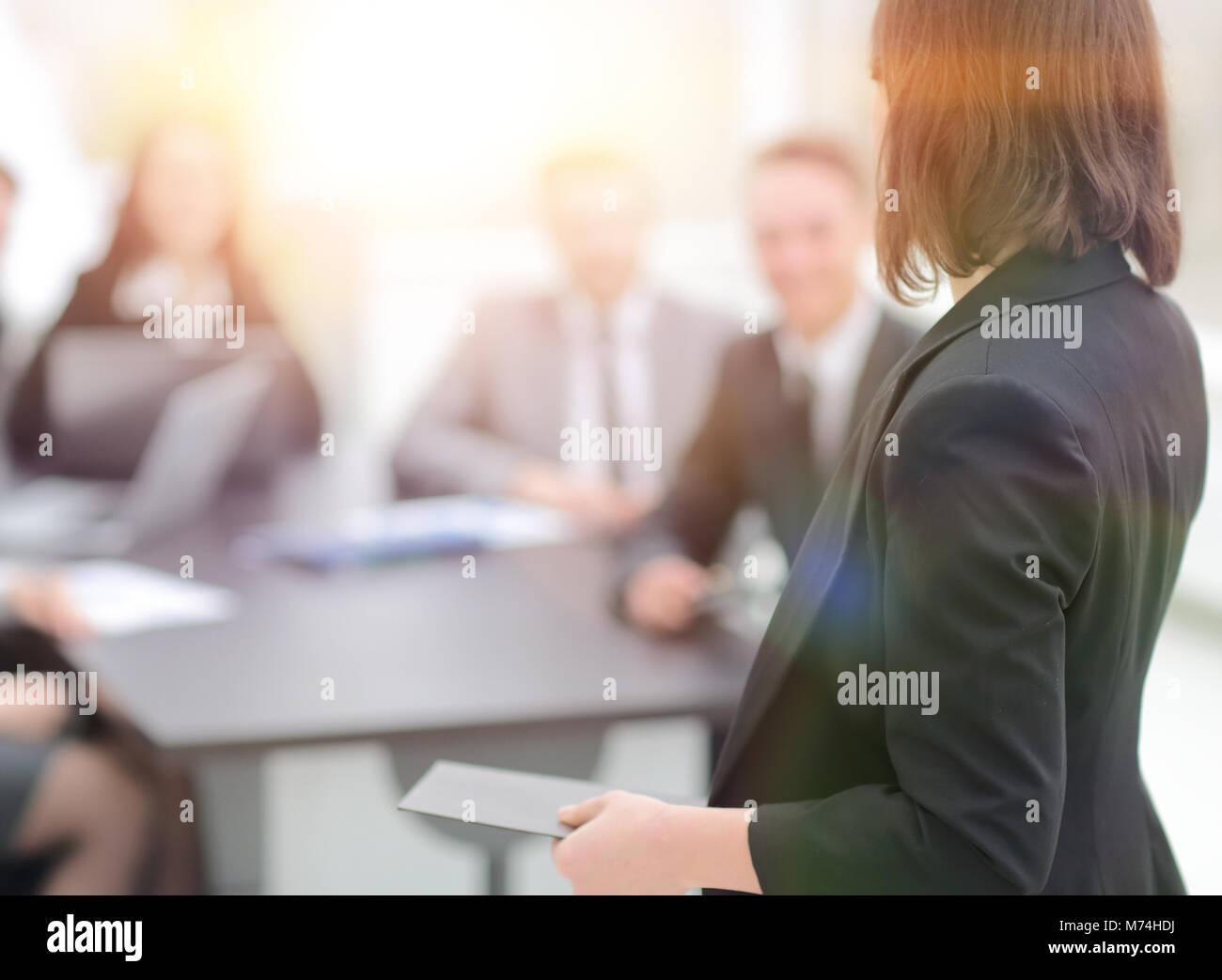 rear view.business woman on blurred background Stock Photo - Alamy