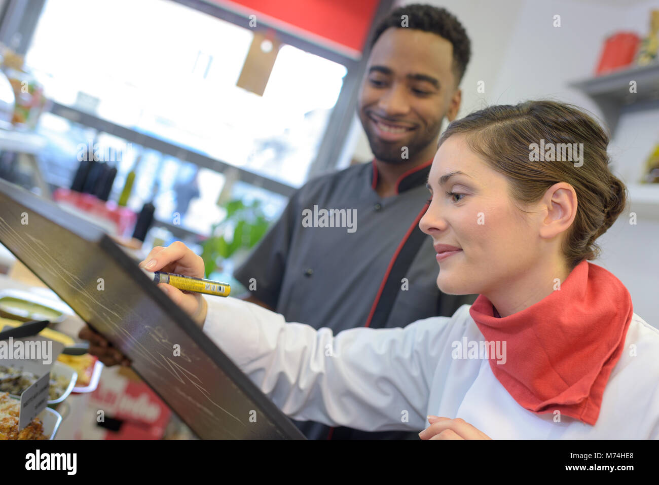 chef writing on specials board in restaurant Stock Photo - Alamy