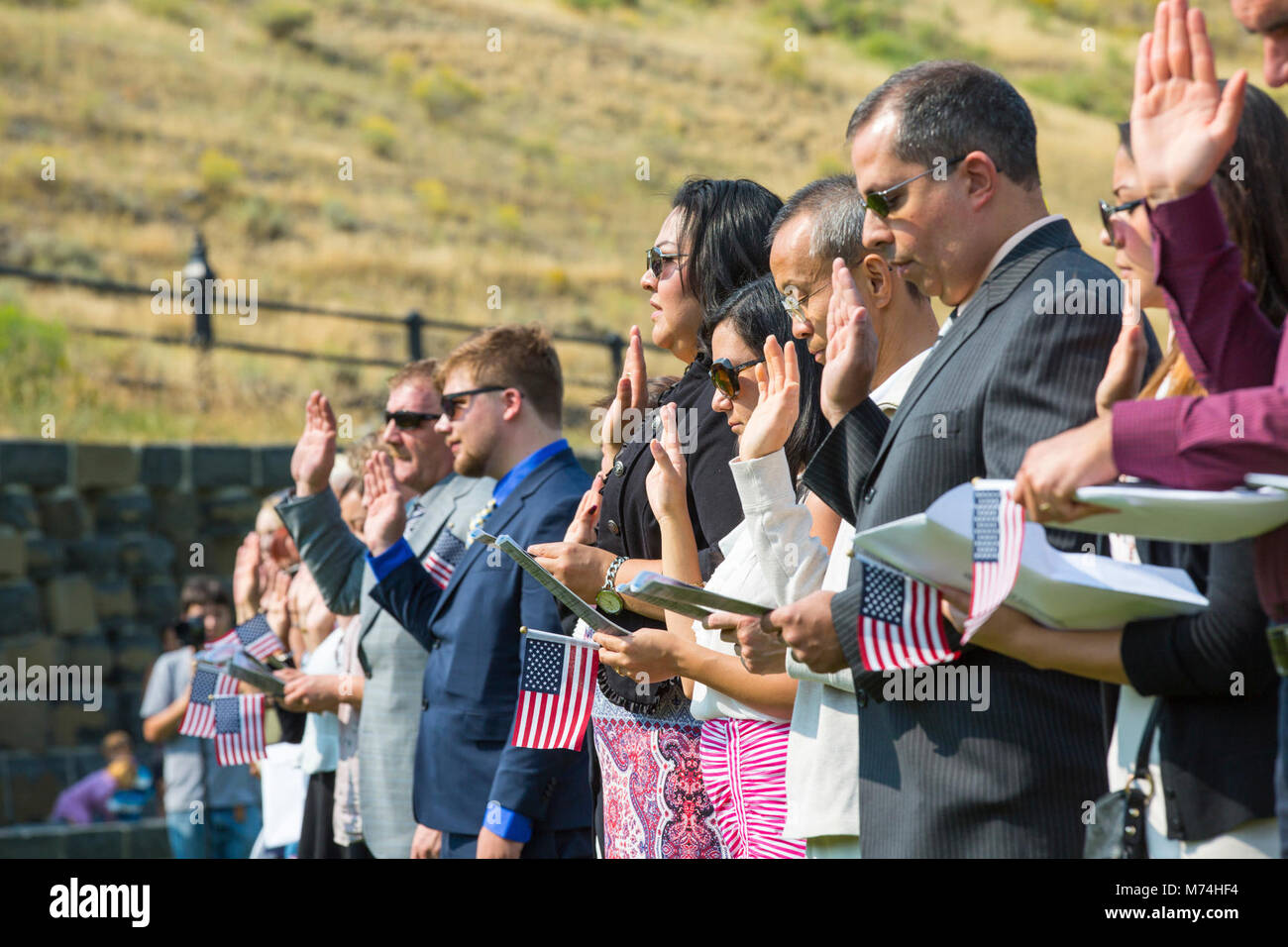 Applicants take the Oath of Allegiance at a naturalization ceremony ...
