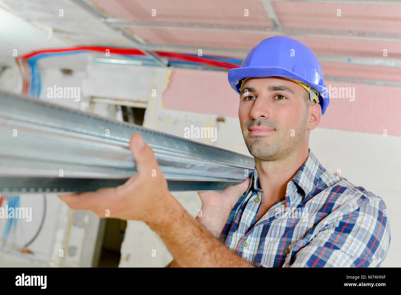 man carrying steel Stock Photo - Alamy