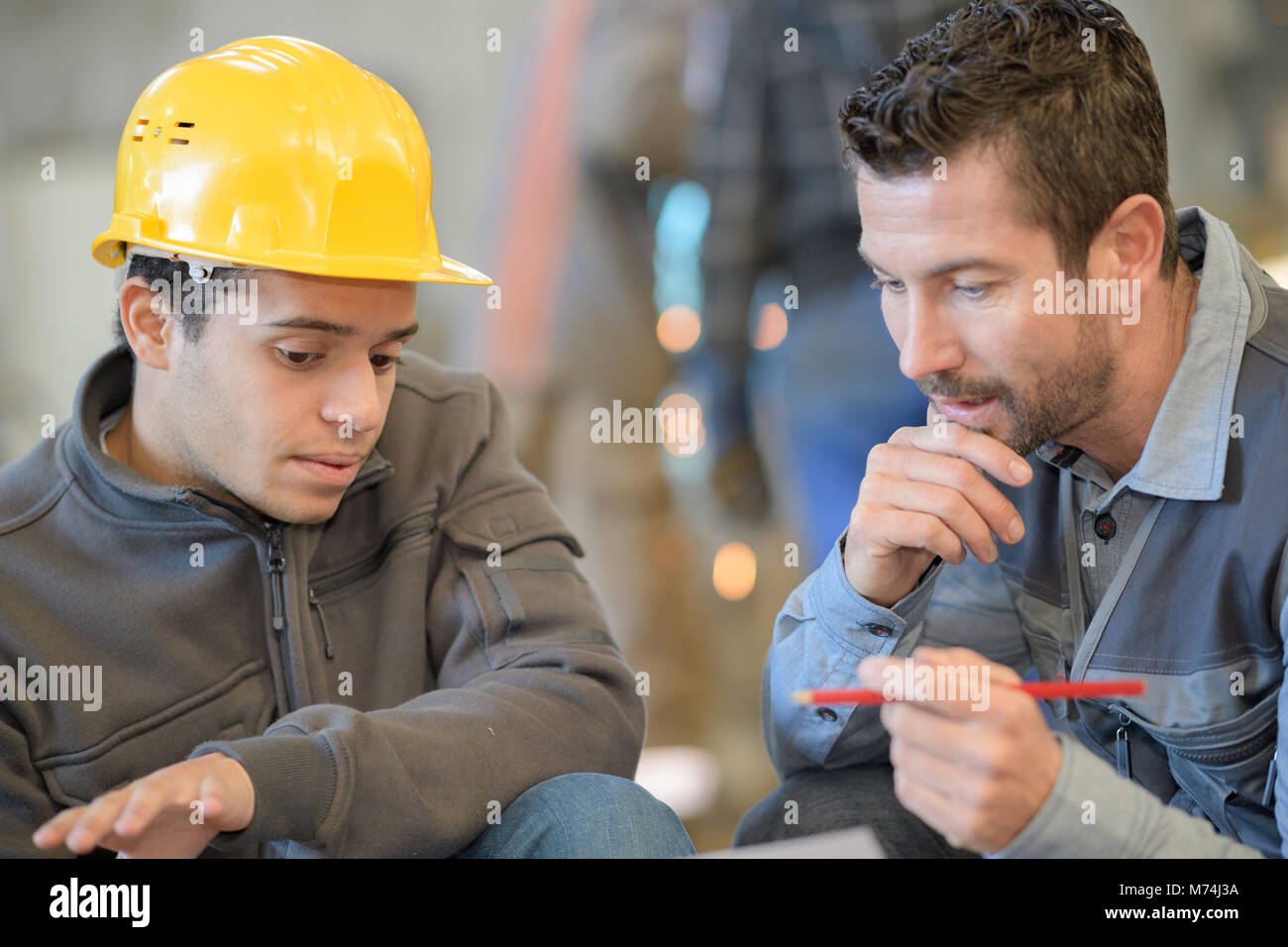 factory workers discussing planning Stock Photo - Alamy