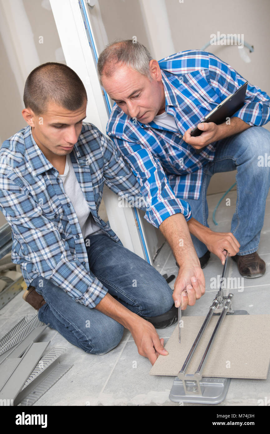 Construction workers laying tile hi-res stock photography and images ...