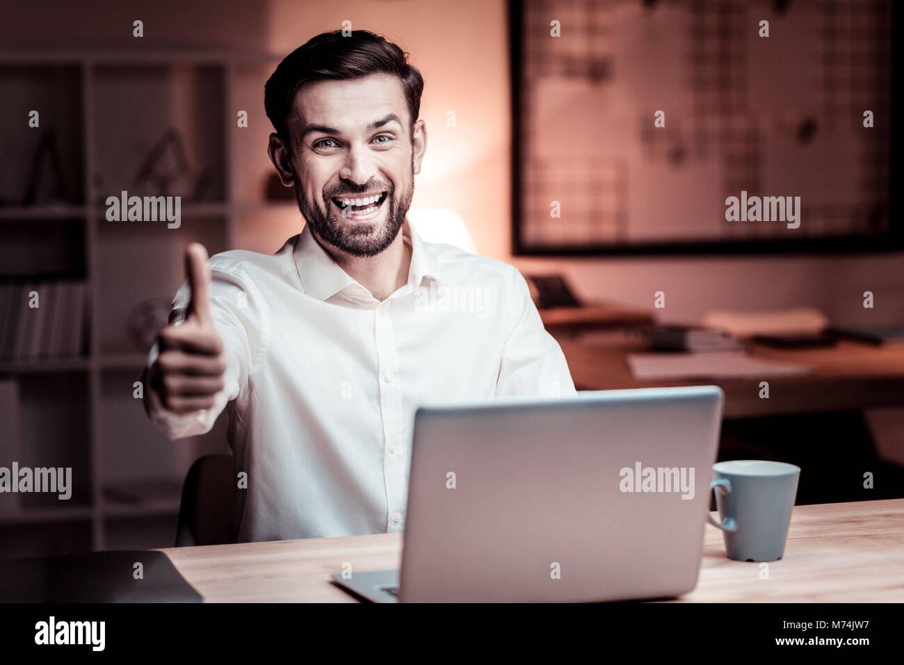 Satisfied happy man working and rejoicing Stock Photo - Alamy