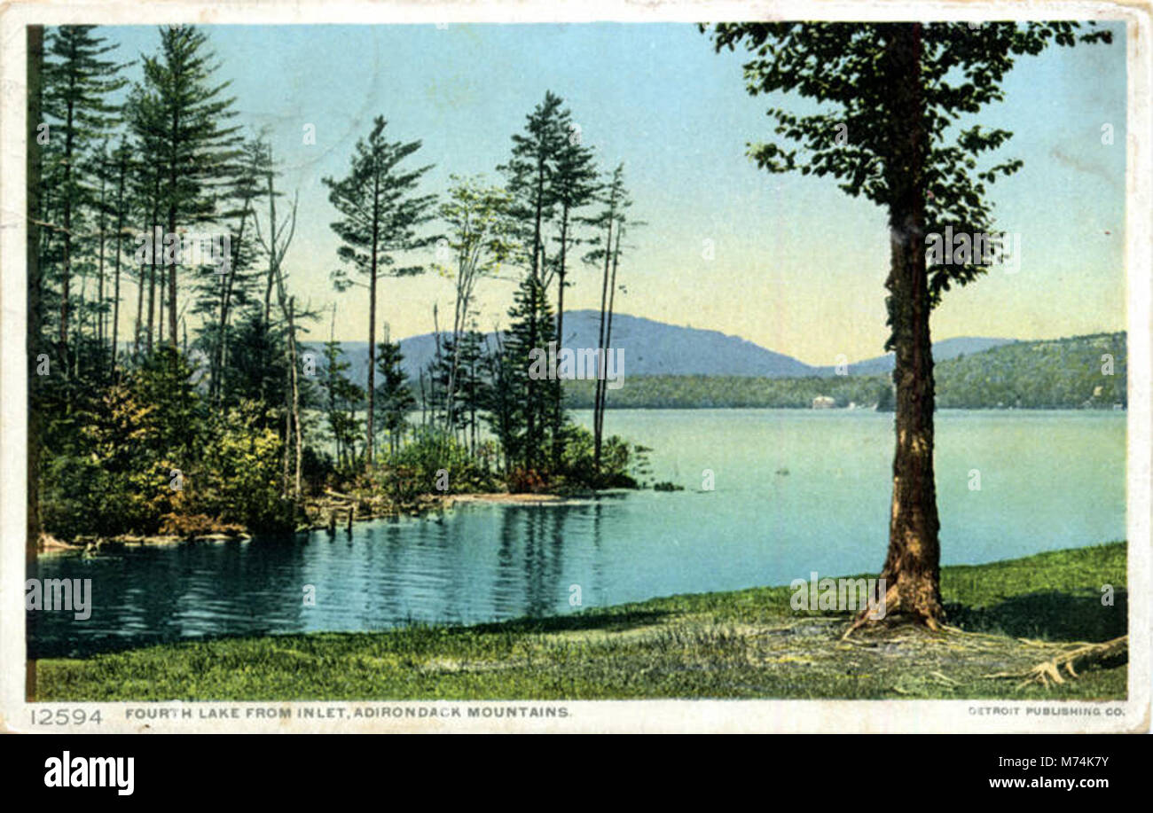 A serene view of Fourth Lake from its inlet. The photograph captures ...