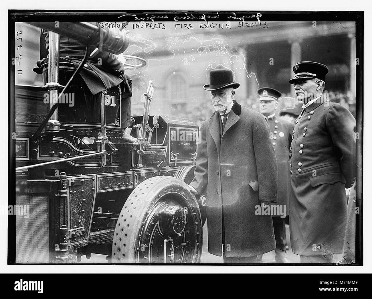 A photograph of Gaynor inspecting a fire engine. The image captures the ...