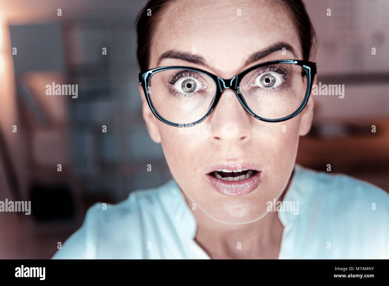 Amazed bespectacled woman looking having astonishment Stock Photo - Alamy