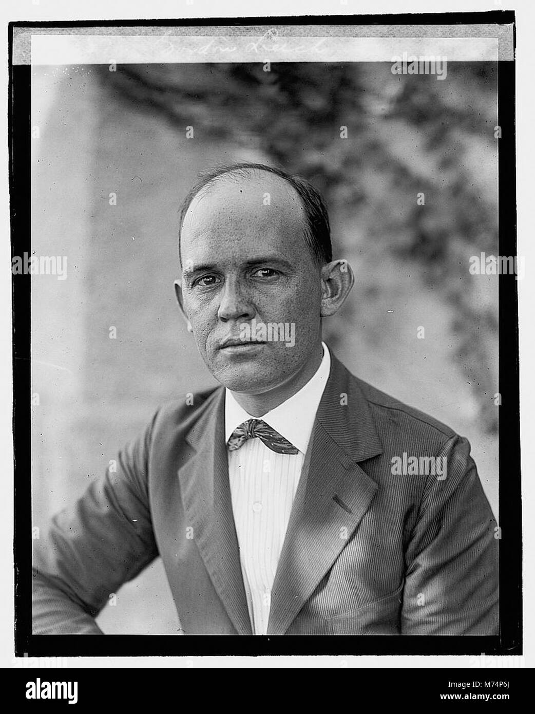 A portrait of Gordon Leech, captured in a formal setting. The image ...