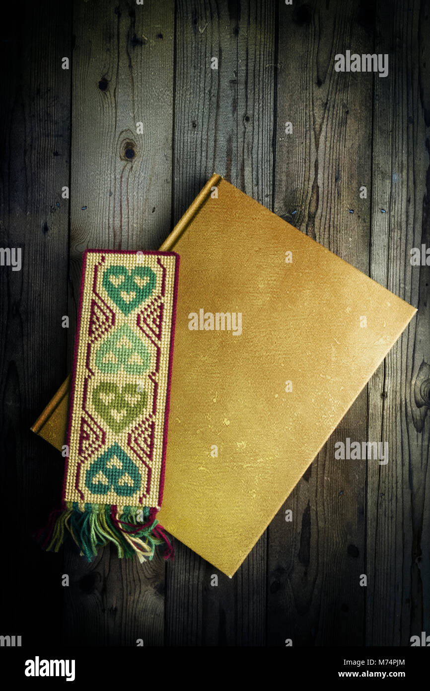 Plain book with embroidered bookmark Stock Photo - Alamy