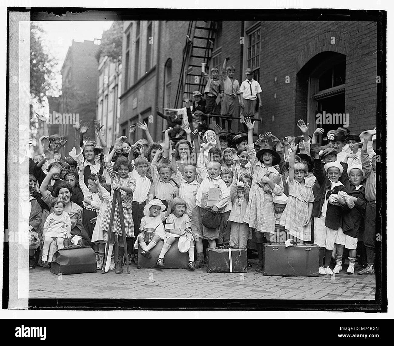 A group portrait of children waving, captured on July 24, 1922 ...