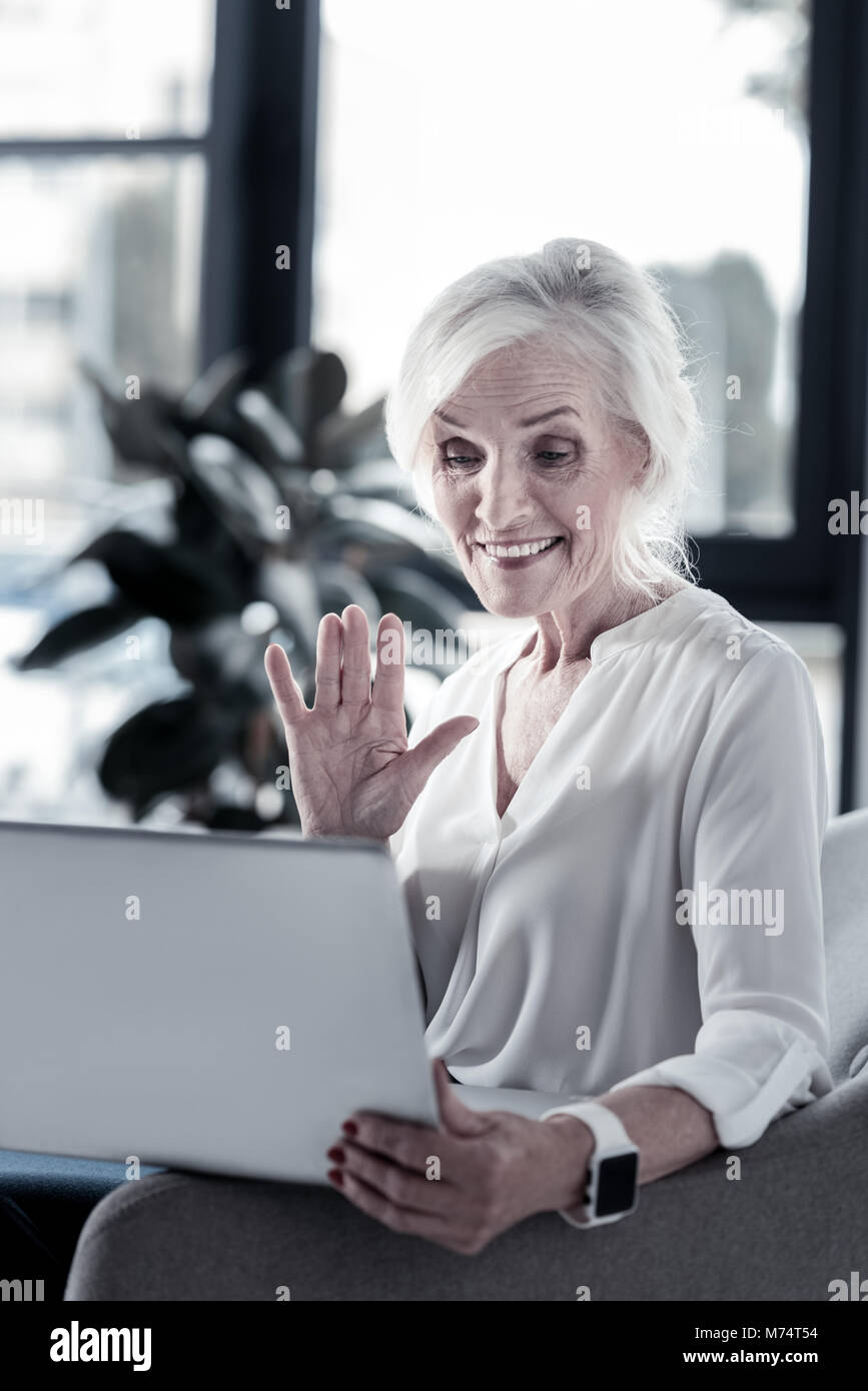 Happy woman waving her hand Stock Photo - Alamy