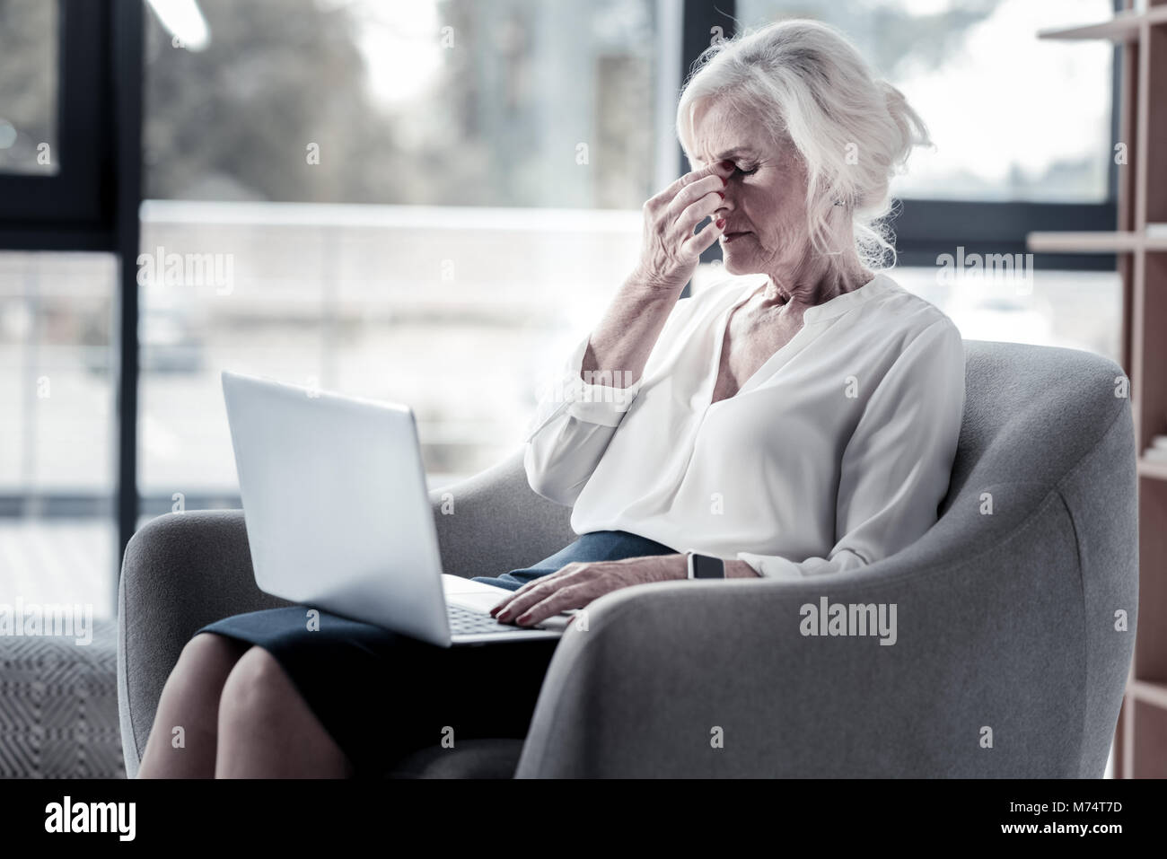 Tired female person sitting in cozy coach Stock Photo - Alamy