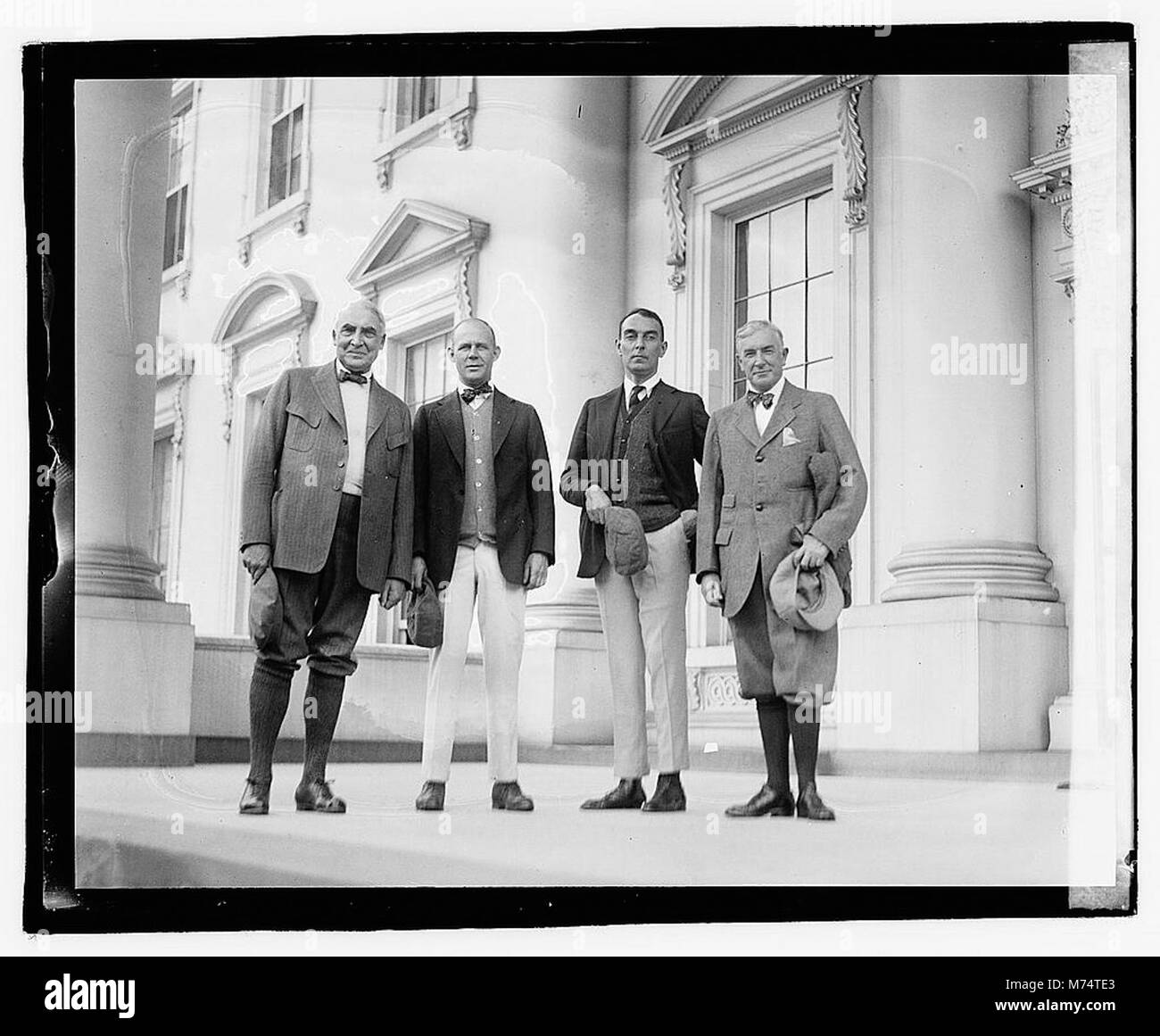 The photograph captures notable figures such as Harding, Grantland Rice ...