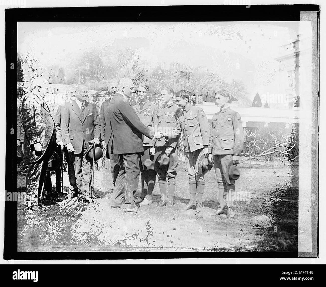 A photo of President Warren G. Harding with a group of individuals ...