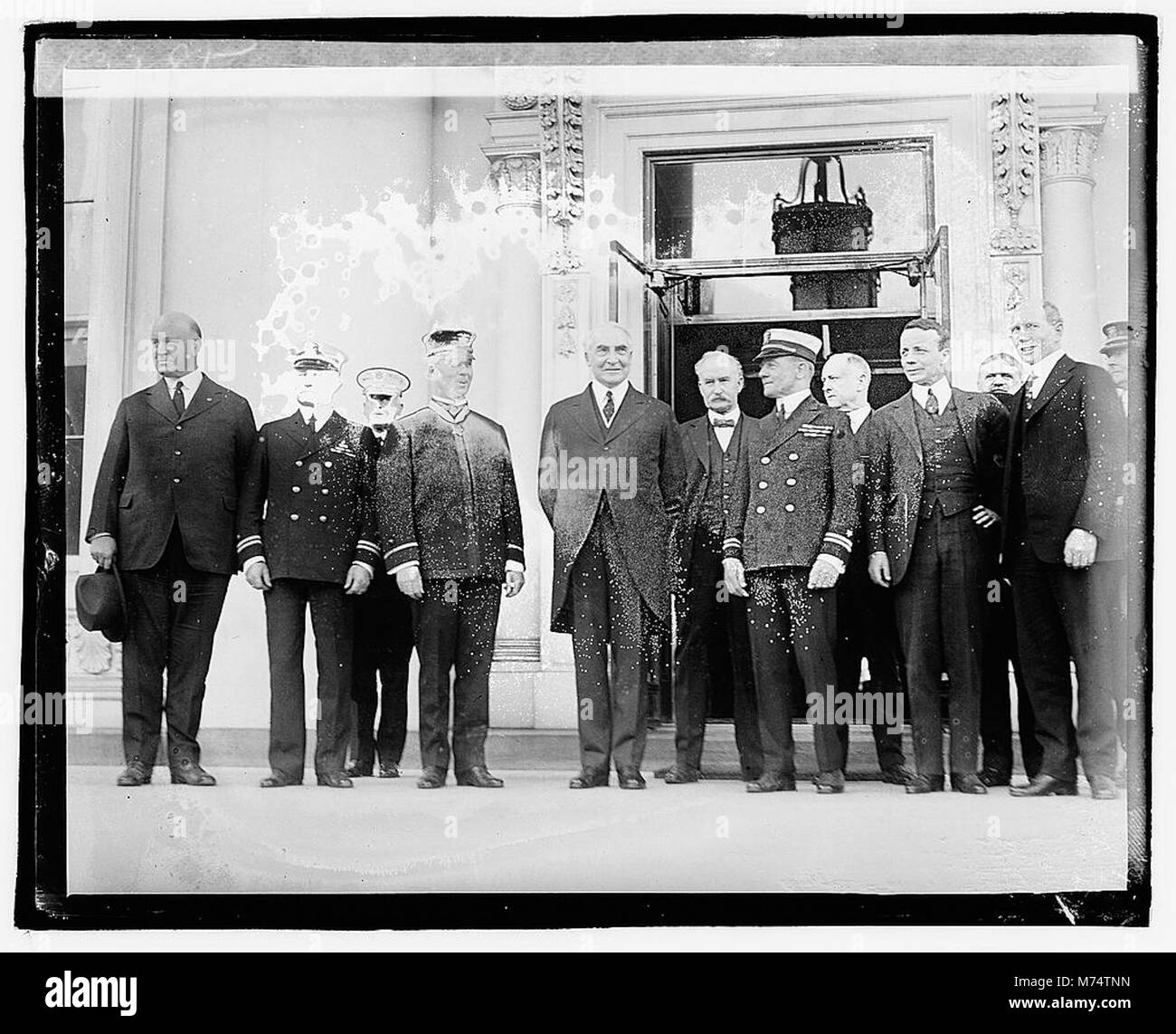A photograph of President Warren G. Harding with a group of individuals ...
