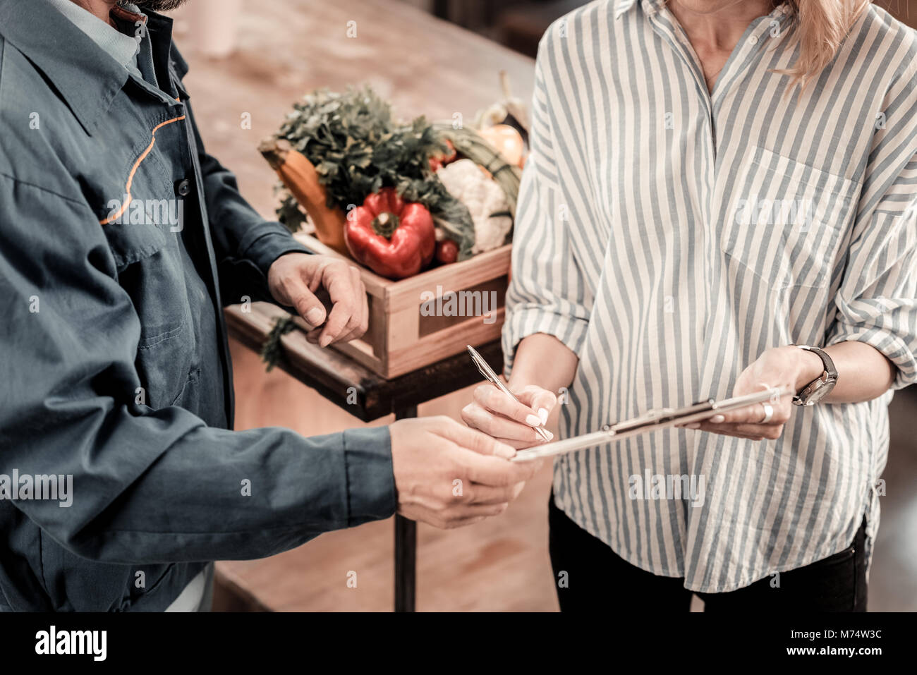 Nice young woman putting her signature Stock Photo - Alamy