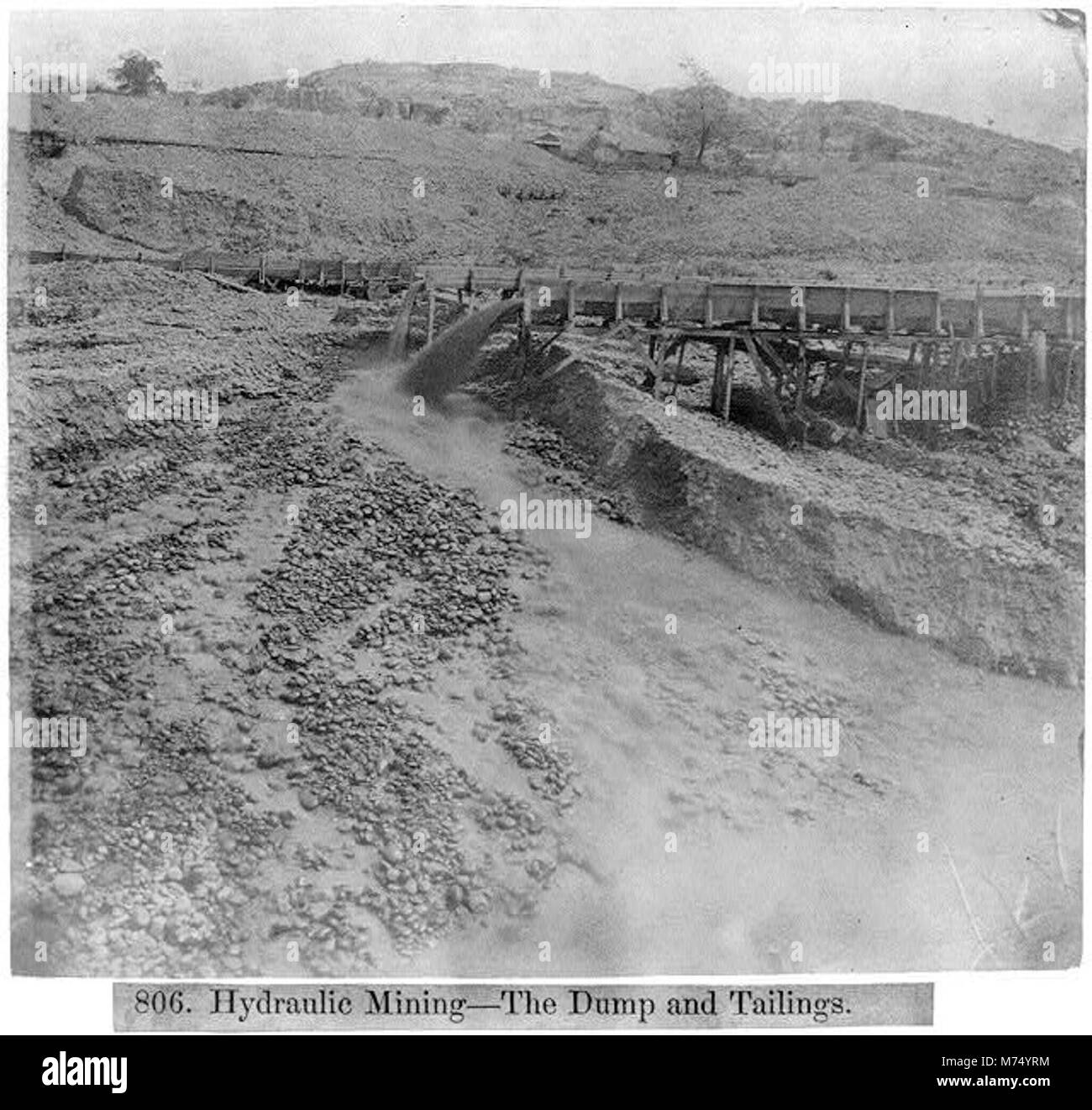 A photograph illustrating hydraulic mining operations, showing waste ...