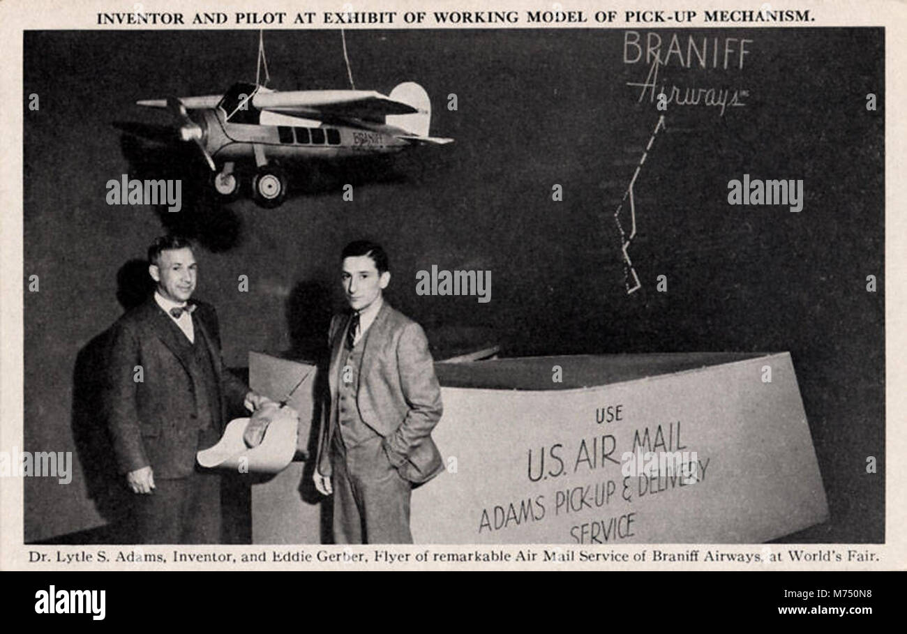 An inventor and pilot stand beside a working model of a pick-up ...
