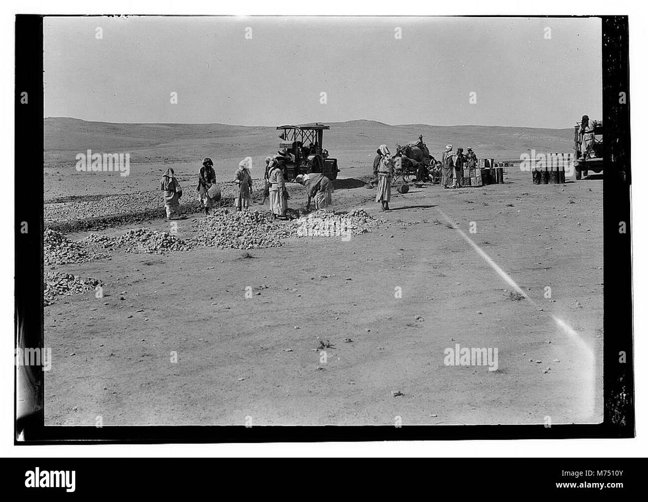 A photograph depicting men working with machinery in Gayara, Iraq ...