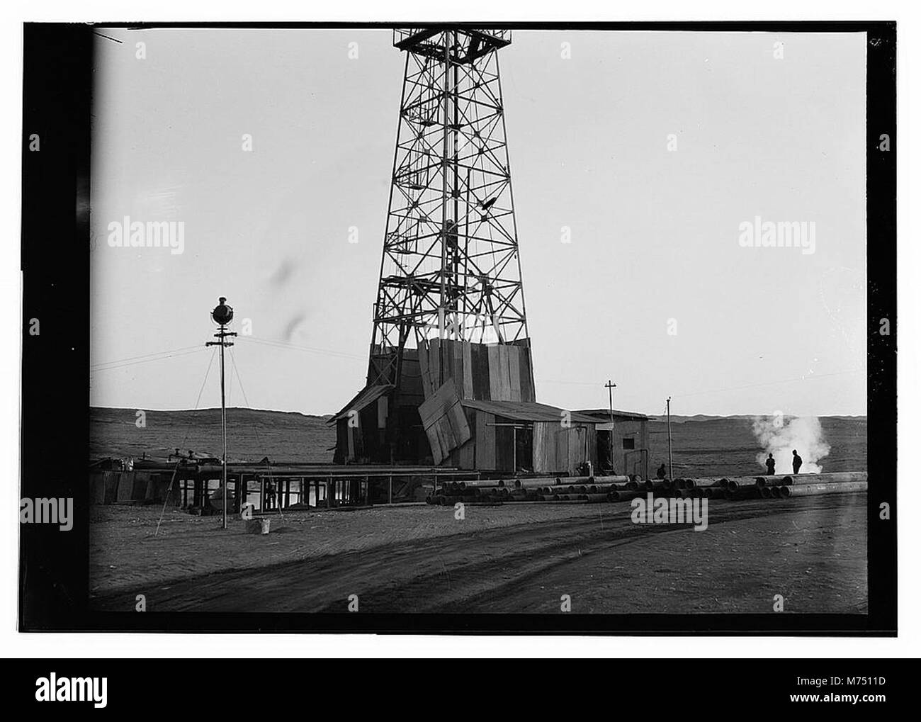 Oil fields in Iraq are shown with drilling towers in operation. The oil ...