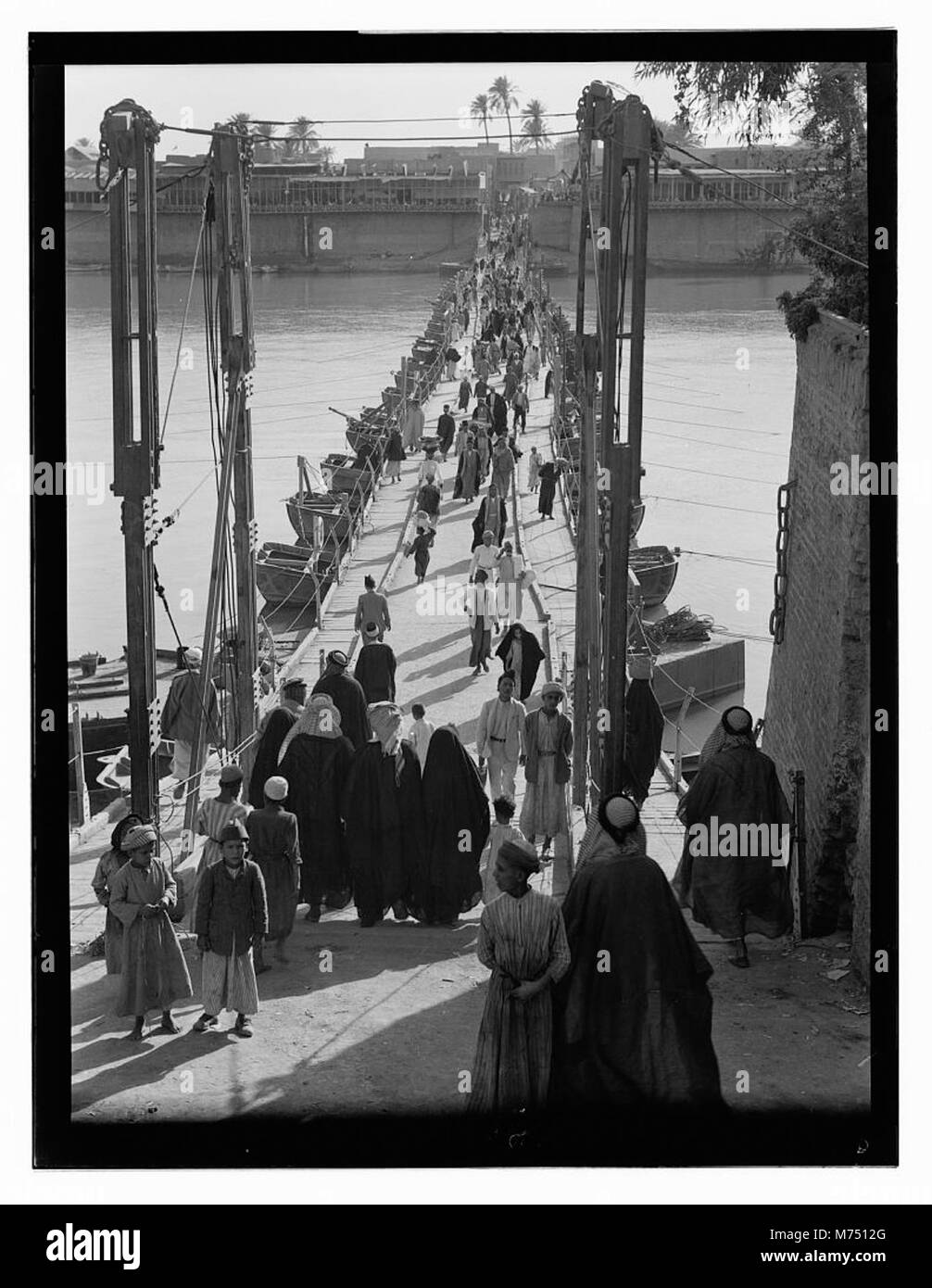 A historical photograph of Baghdad, Iraq, showing street scenes, local ...