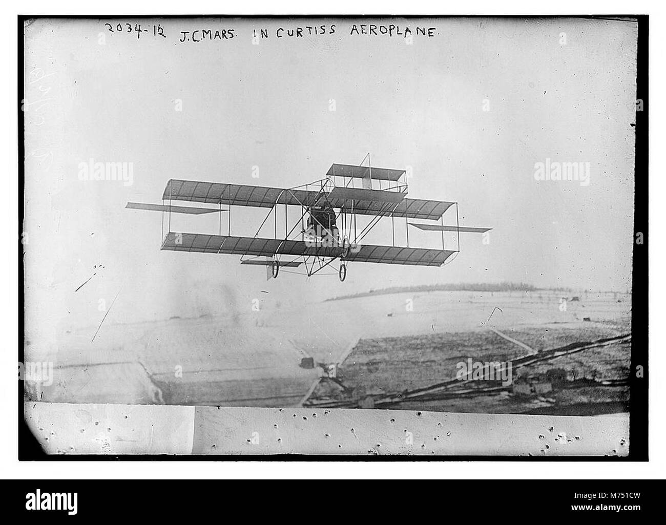 J.C. Mars is seen in a Curtiss aeroplane, highlighting the early days ...