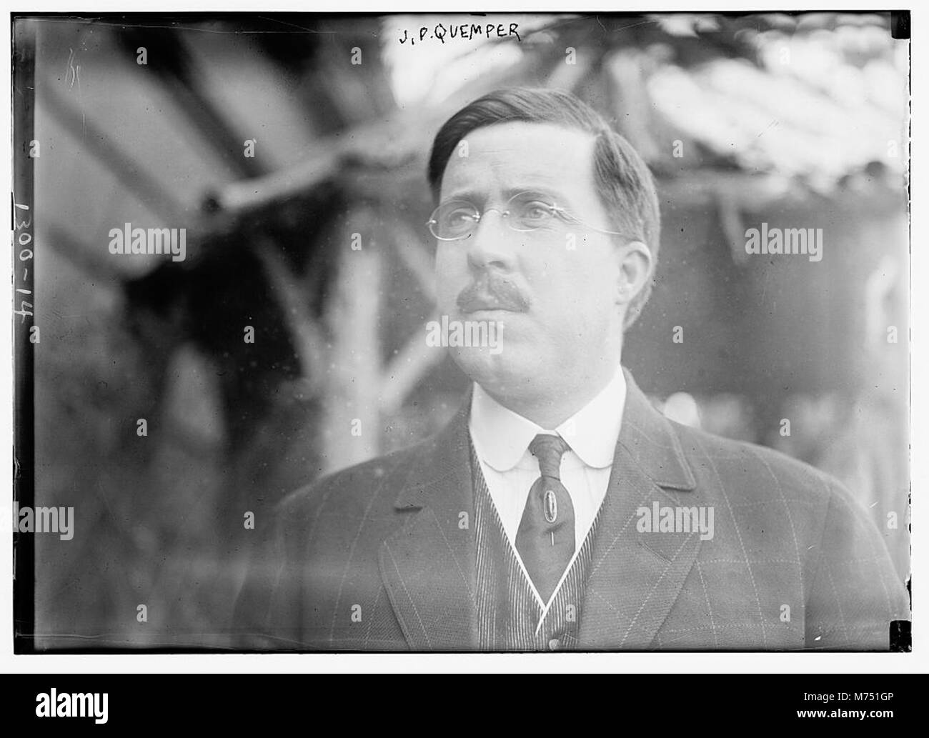 J.P. Quemper is featured in this historical photograph. The image ...
