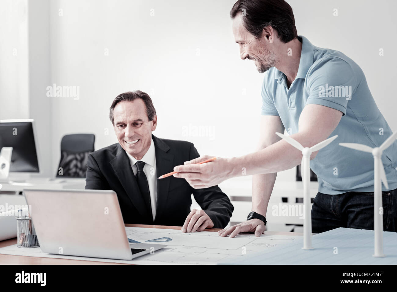 Attentive male person looking at screen of computer Stock Photo - Alamy