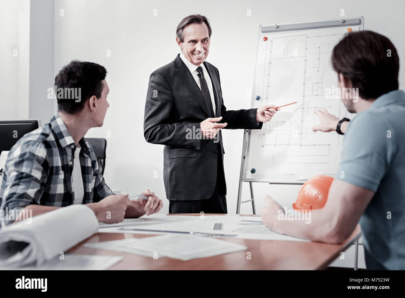 Handsome brunette presenting his sketch Stock Photo - Alamy