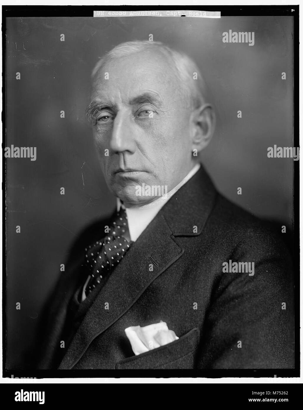This photograph features Captain Roald Amundsen, known for his ...