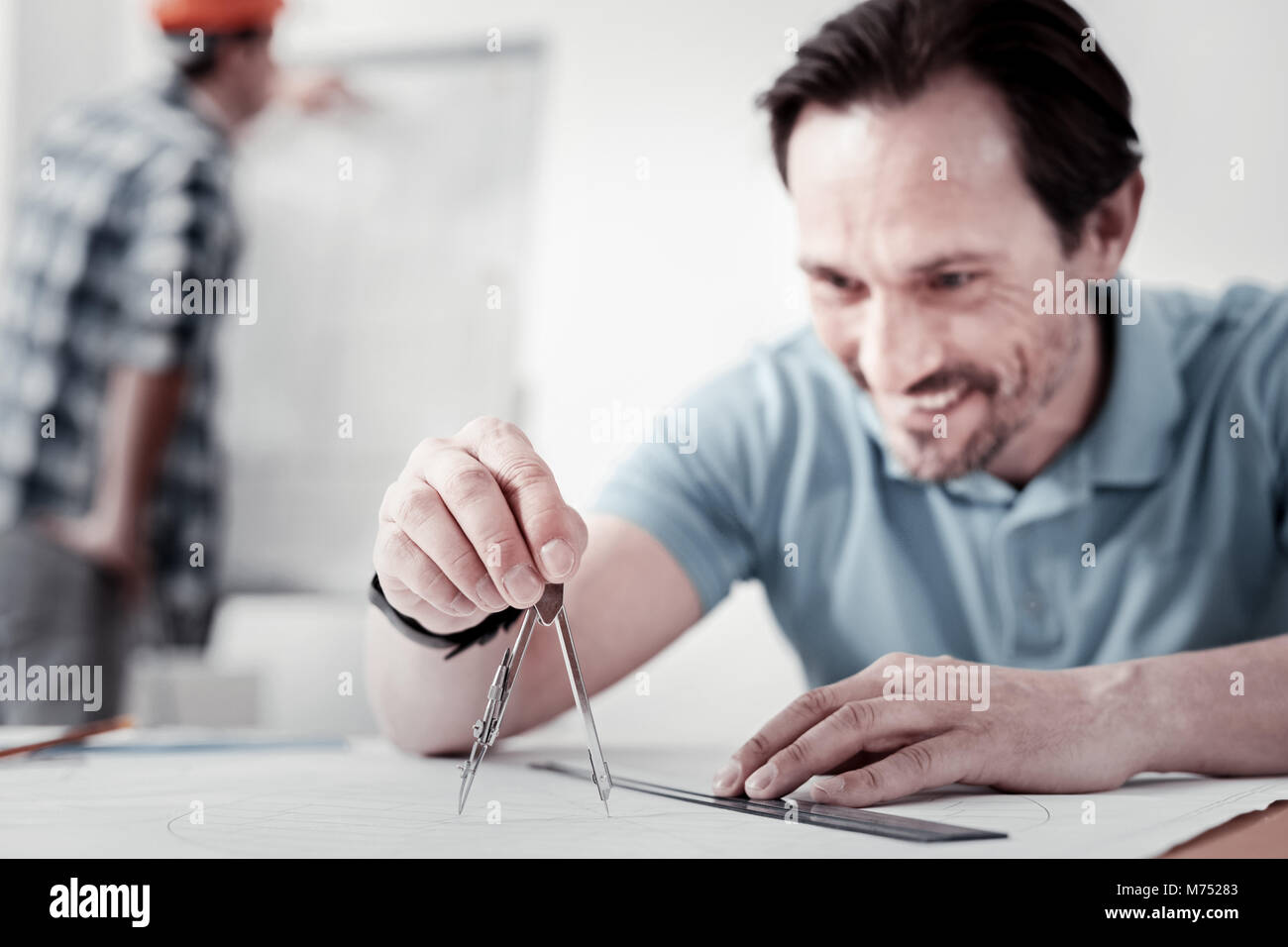 Delighted architect drawing big circle Stock Photo - Alamy