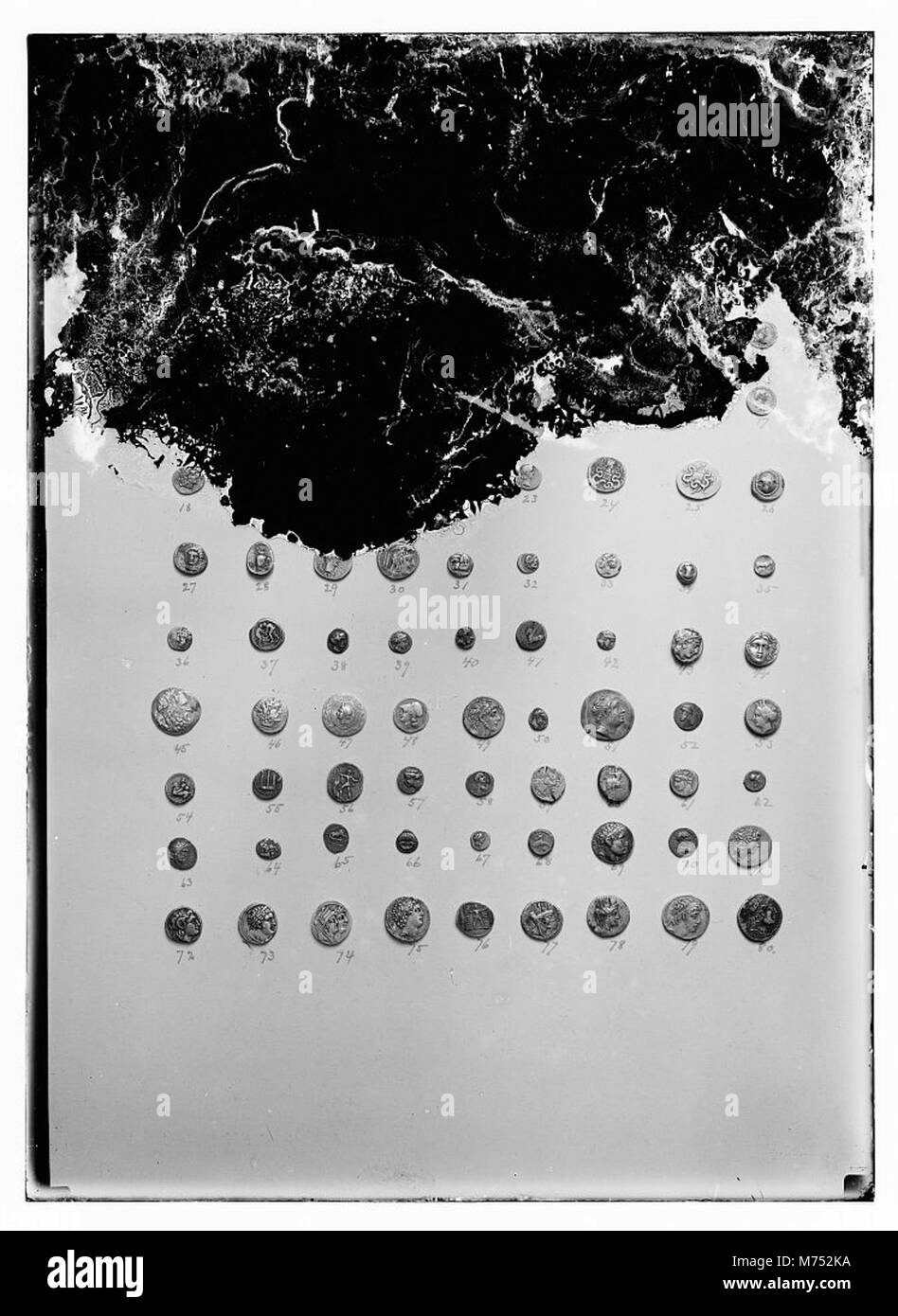 This image features a collection of ancient coins, showcasing various ...