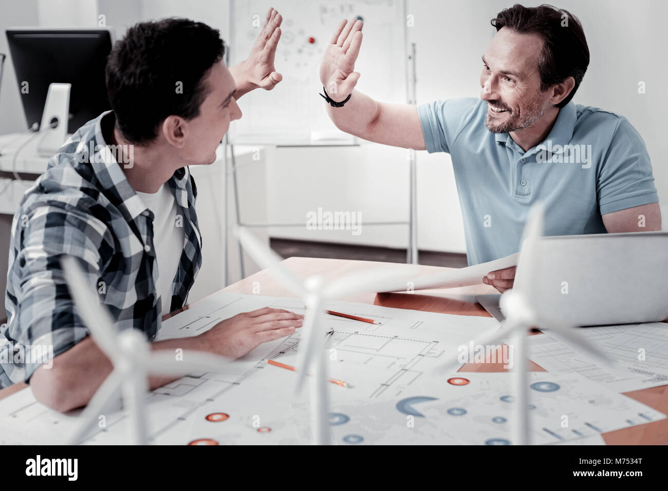 Positive delighted colleagues touching hands Stock Photo - Alamy