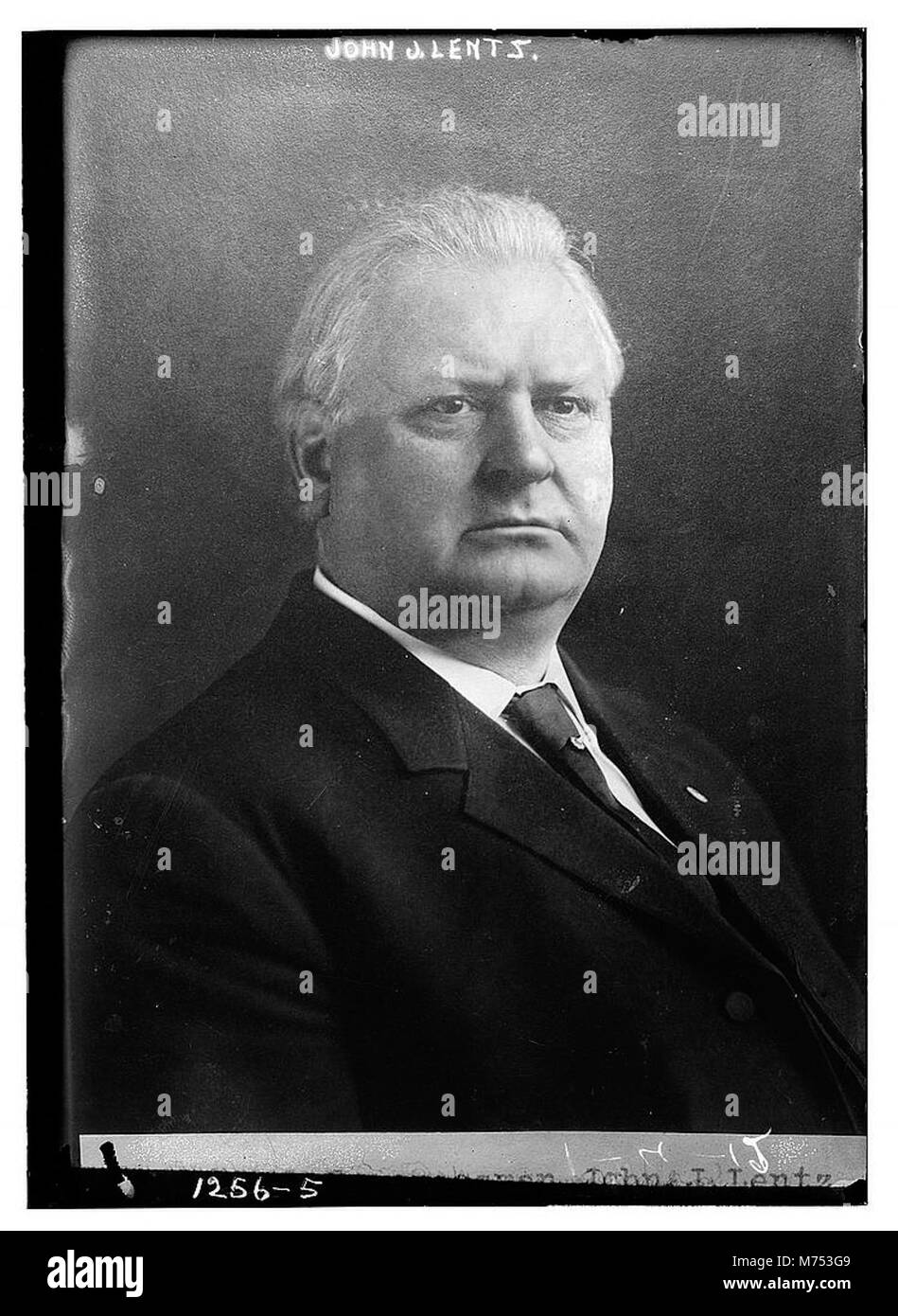A formal portrait of John J. Lents, an influential figure captured in a ...