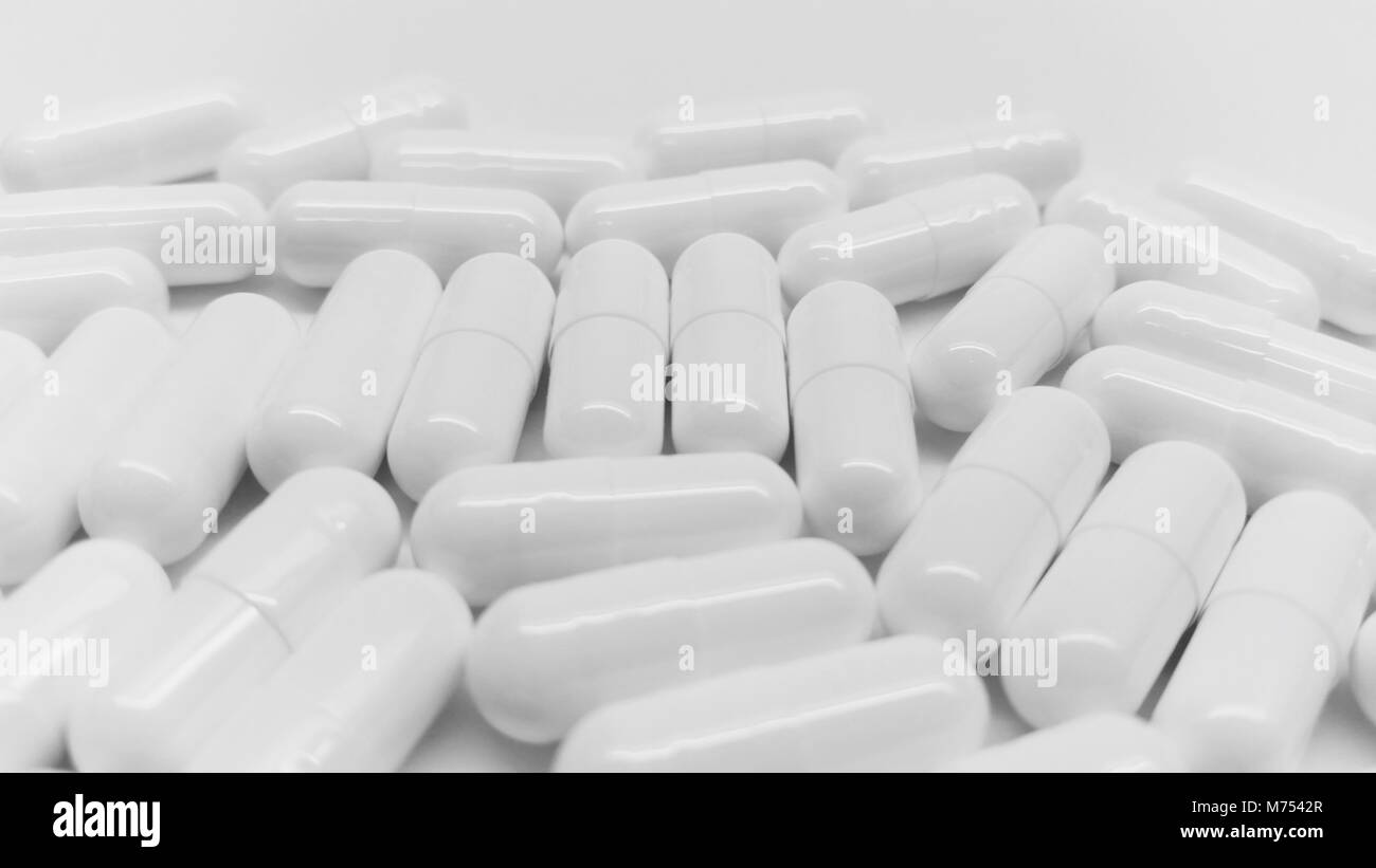 White capsules in the pharmacy laboratory Stock Photo - Alamy
