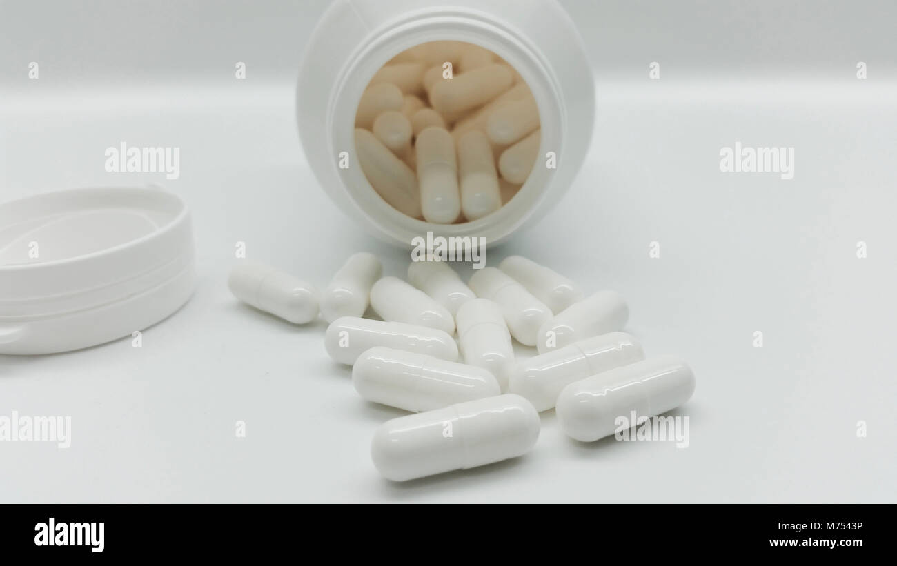 White capsules in the pharmacy laboratory Stock Photo - Alamy