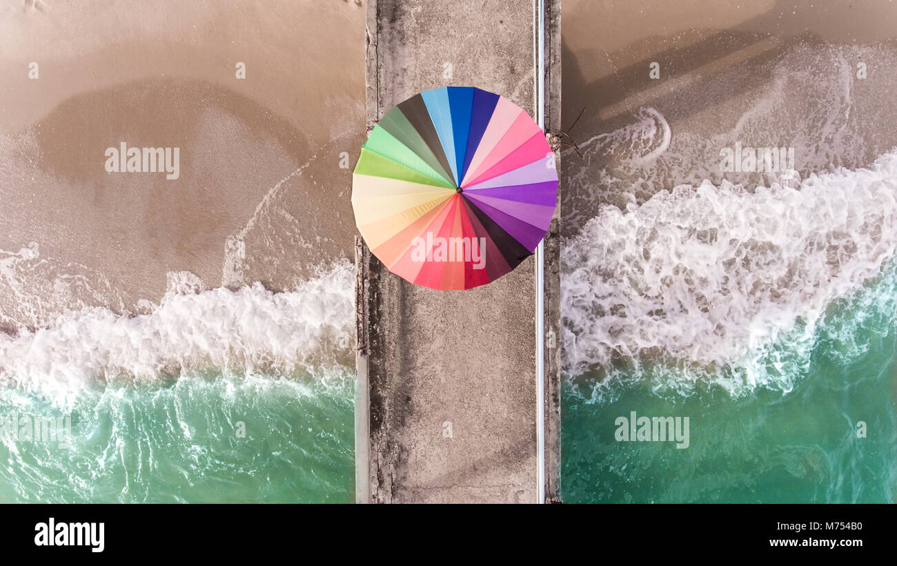 Colorful of umbrella on the beach and foam of sea wave from top eye ...