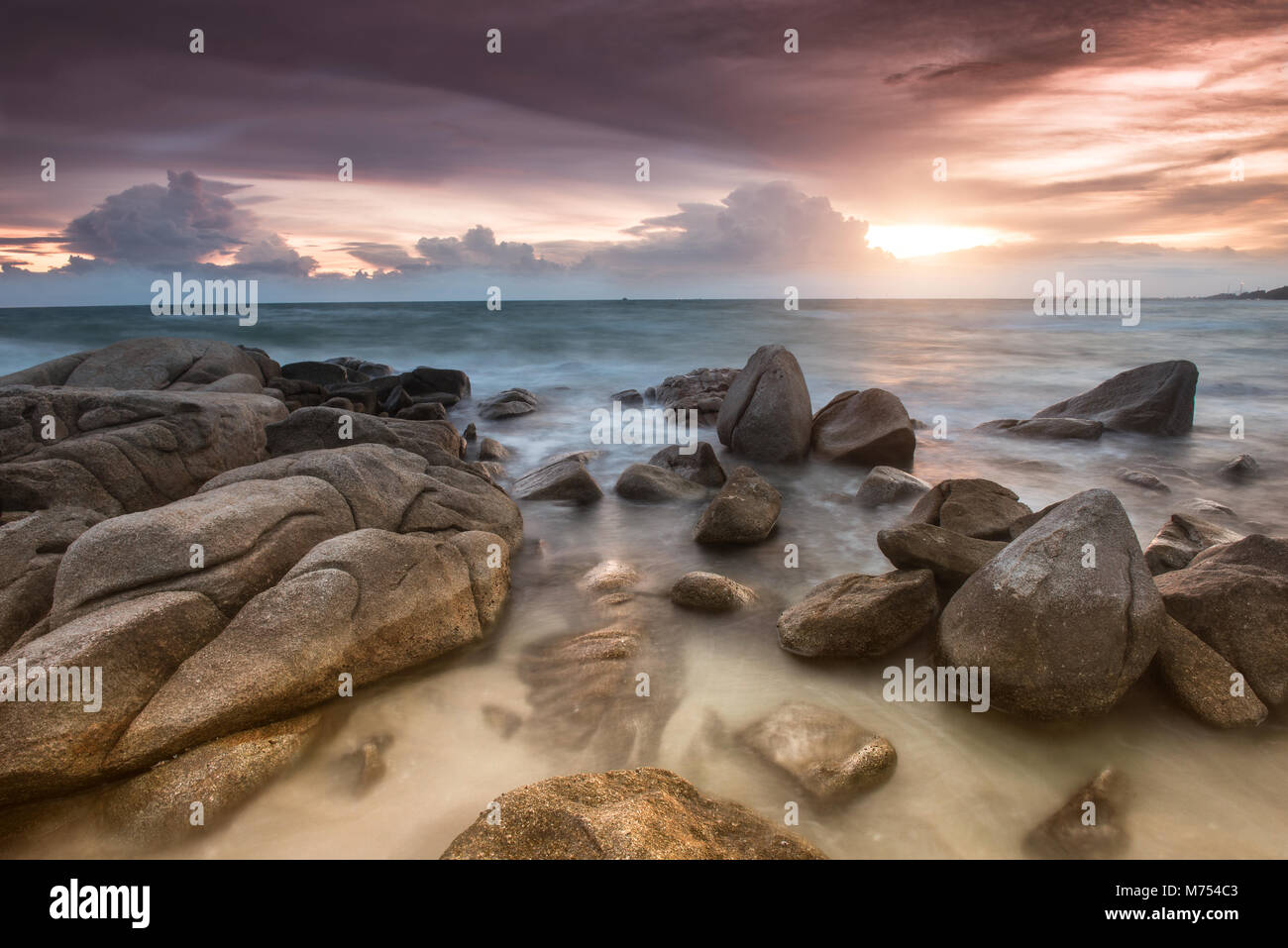 The rock and the sea in the color of sunset time photo with outdoor low ...