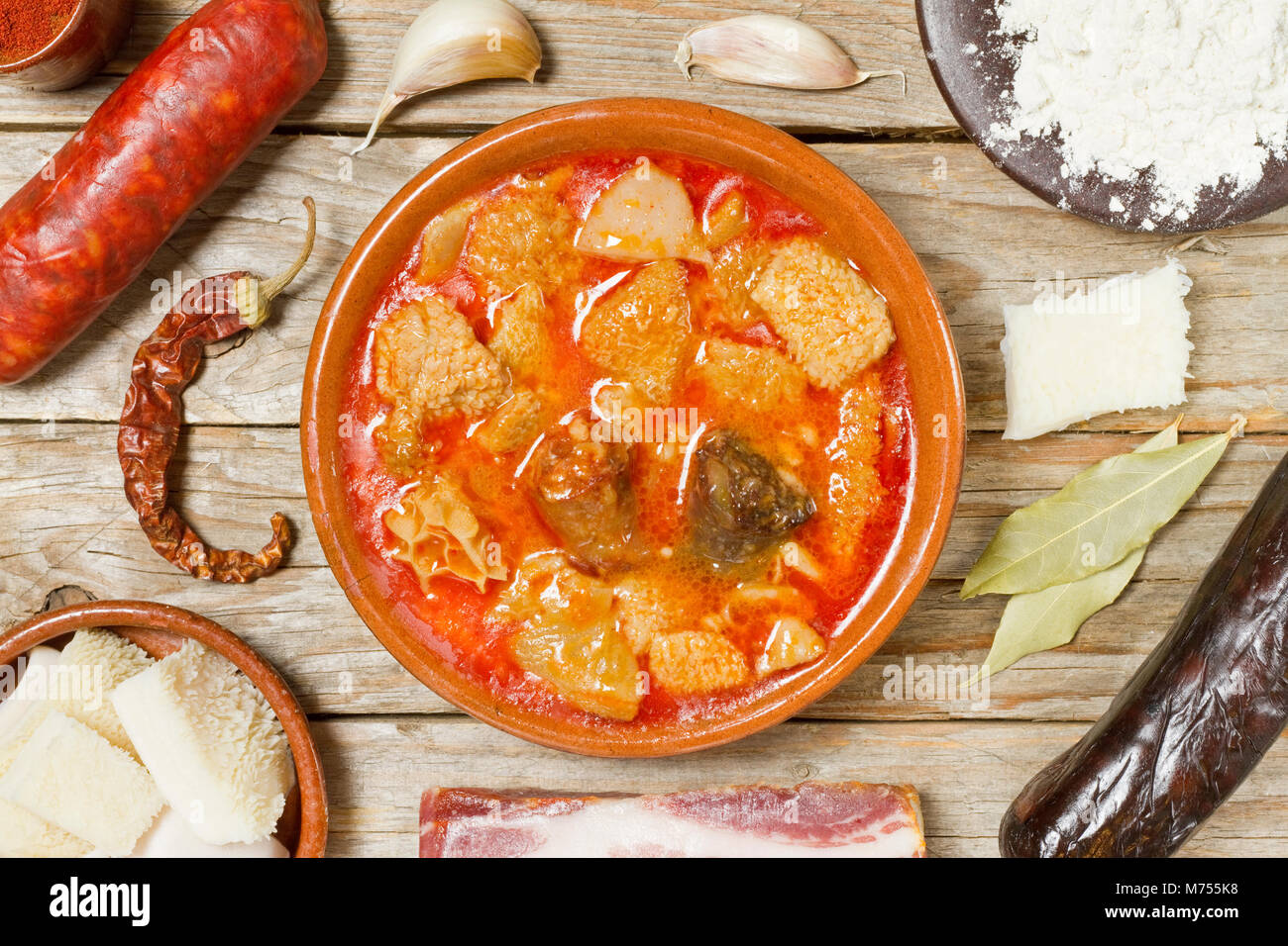 Spanish callos and ingredients on a wooden table Stock Photo - Alamy