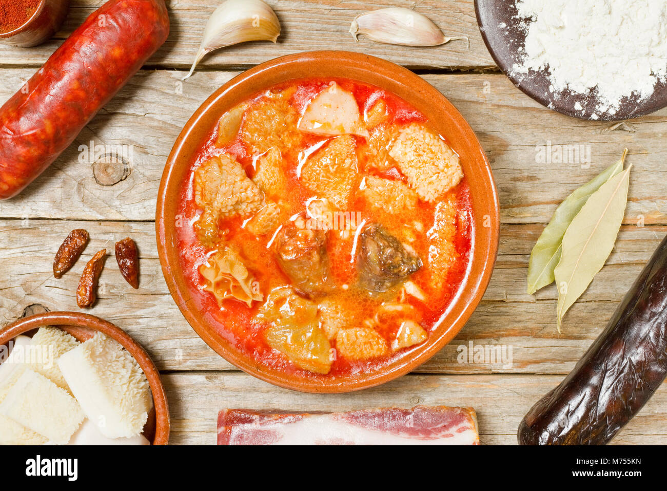 Spanish callos and ingredients on a wooden table Stock Photo - Alamy