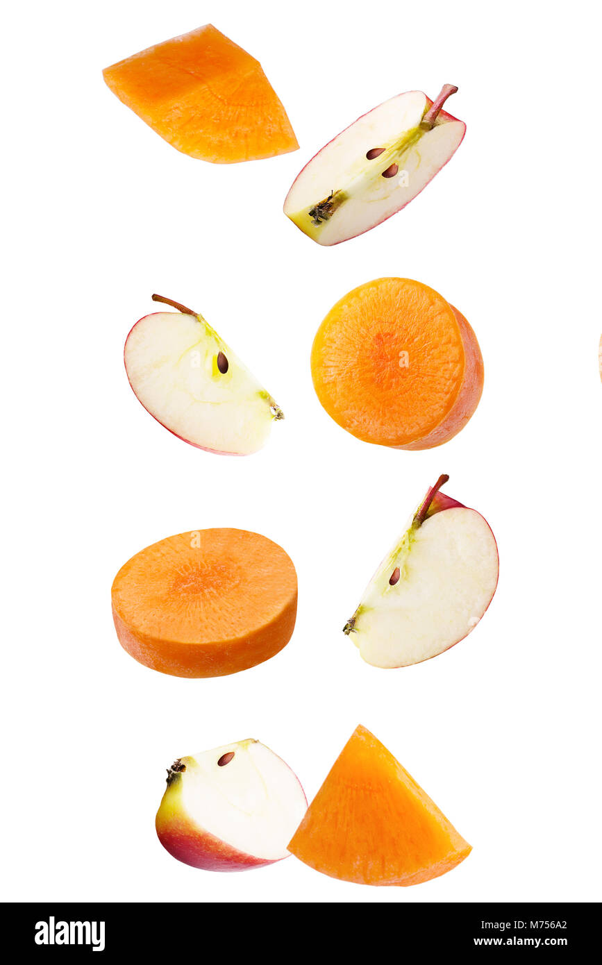 Isolated falling fruits. Falling apple and carrot isolated on white ...